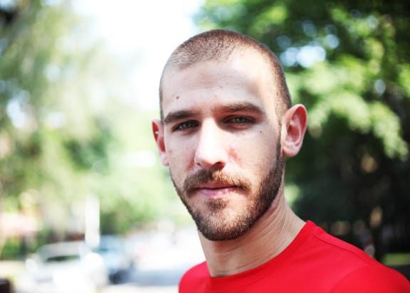 a portrait of a man wearing a red shirt