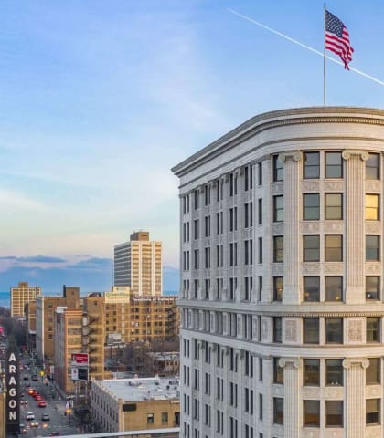 a view of a tall building with an flag on top of it