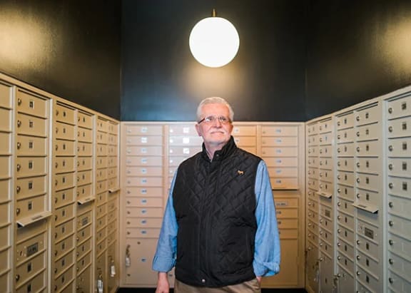 a man standing in front of locker cabinets