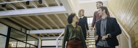 a group of people walking down a staircase in a building